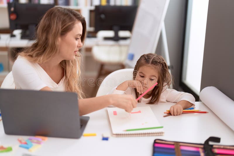 Teacher and Toddler Sitting on Table Drawing on Notebook at Classroom ...