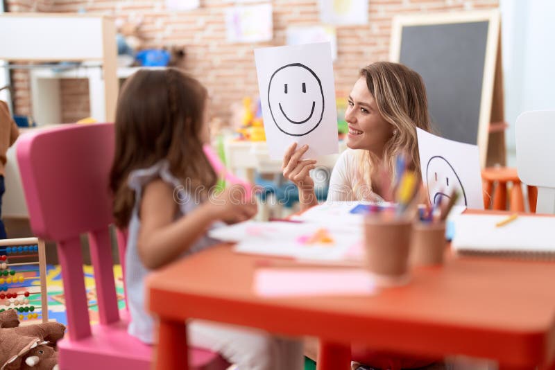Teacher and Toddler Sitting on Table Having Emotion Therapy at ...