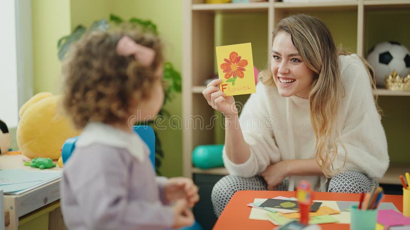 Teacher and Toddler Sitting on Table Having Language Lesson at ...