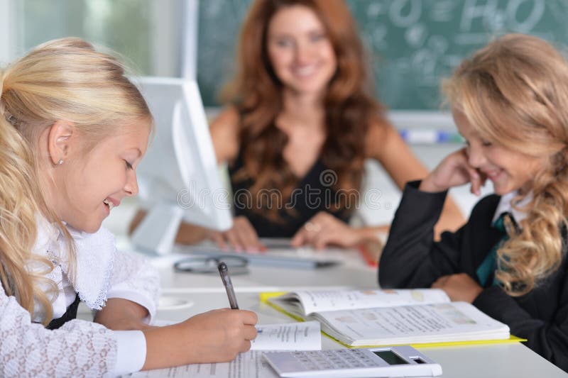 Teacher with two girls stock photo. Image of friendly - 80313982