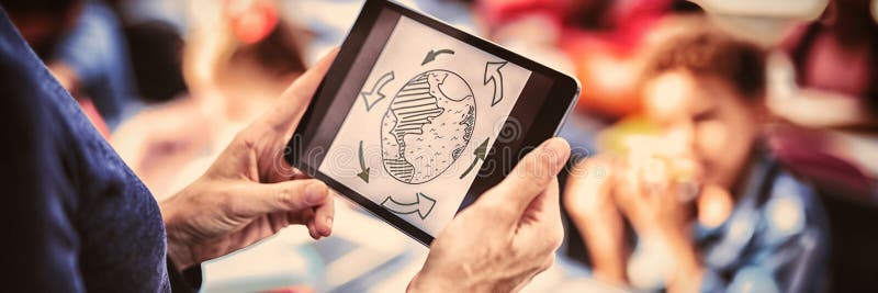 Teacher Using Digital Tablet while Teaching in Classroom Stock Photo ...