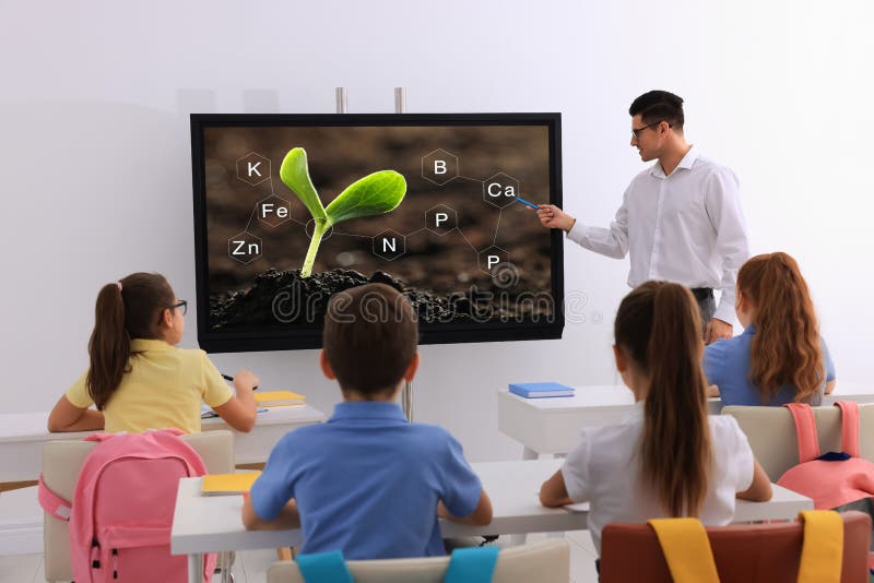 Teacher Using Interactive Board in Classroom during Lesson Stock Photo ...