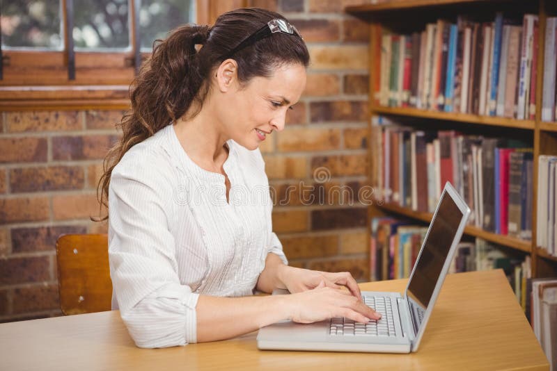 Teacher Using Laptop in Her Office Stock Photo - Image of elementary ...