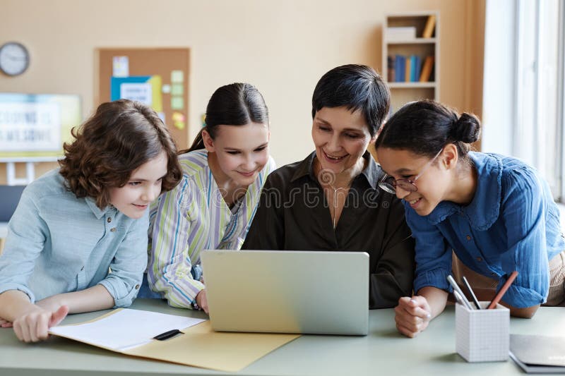 Teacher Using Laptop Together with Children Stock Photo - Image of ...
