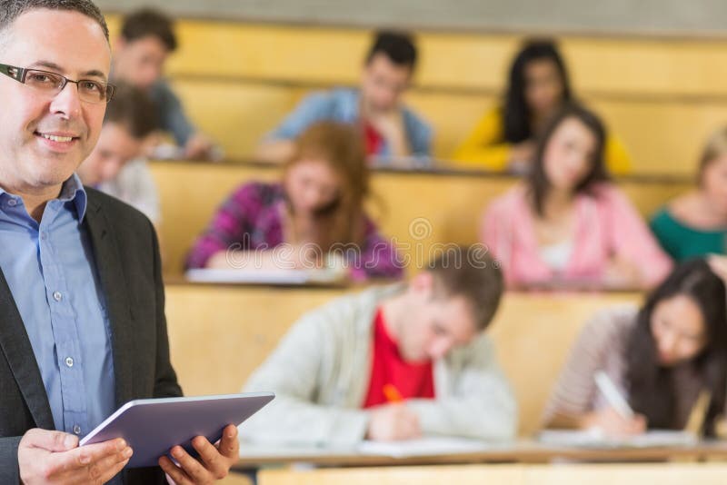 Teacher Using Tablet PC with Students Sitting at Lecture Hall Stock ...