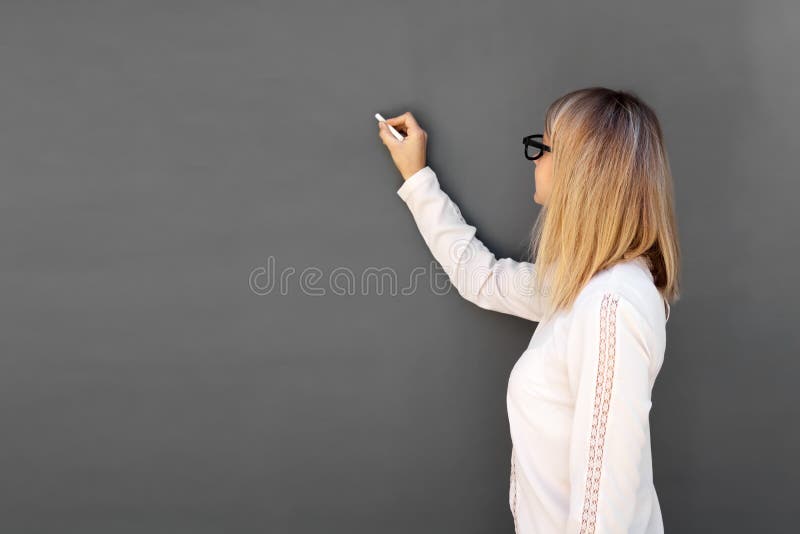 A Teacher Writes on Blackboard at School Stock Image - Image of hair ... A Teacher Writes on Blackboard at School Stock Image - Image of hair ...
