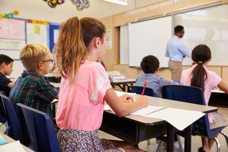 Teacher Writing on the Board in an Elementary School Class Stock Photo ...