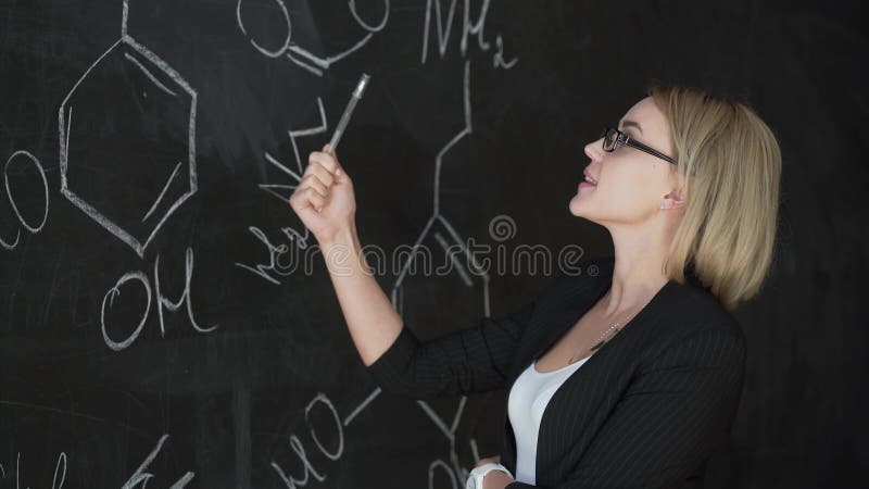 Teacher Writing Formulas on the Chalk Board and Explains the Students ...