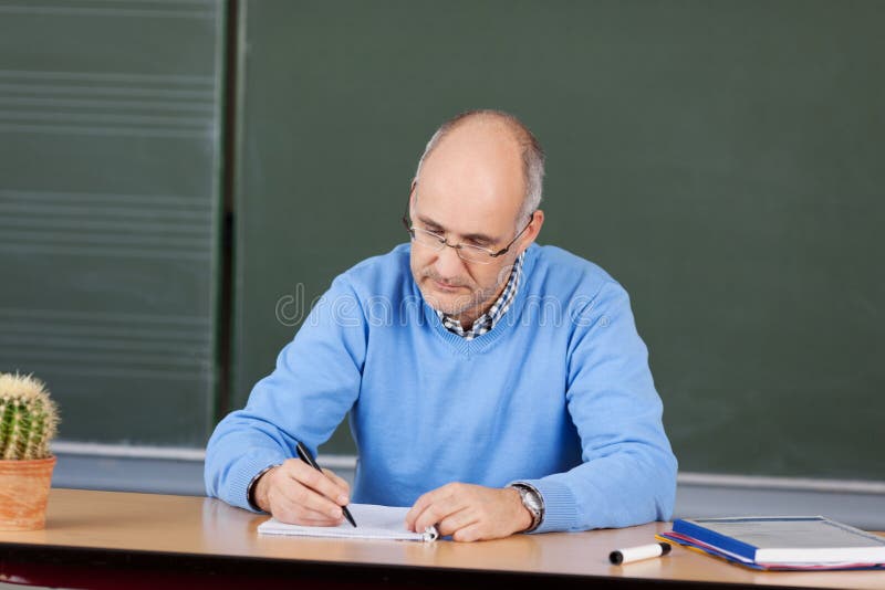 Teacher Writing Notes at His Desk Stock Image - Image of educator ...