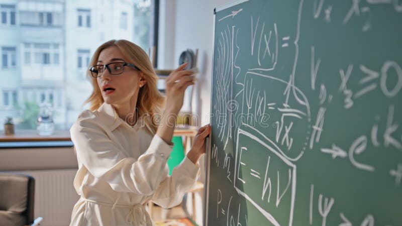 Teacher Writing Physic Formulas on Blackboard Explaining Information ...