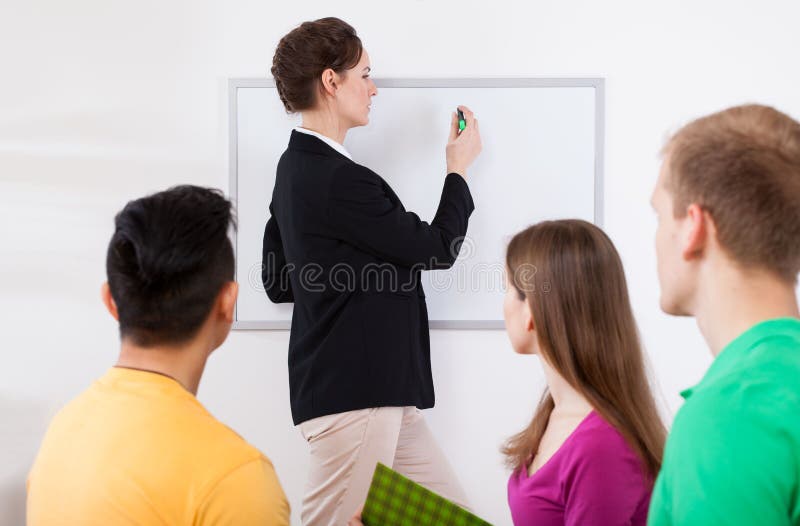 Teacher Writing on Whiteboard at Classroom Stock Photo - Image of ...