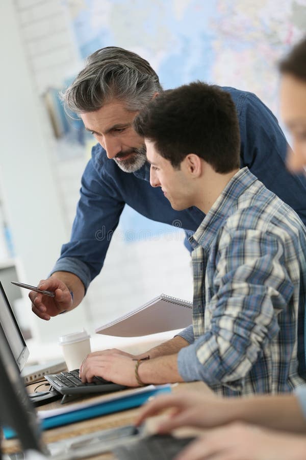 Teacher with Young People in Class Explaining Stock Photo - Image of ...