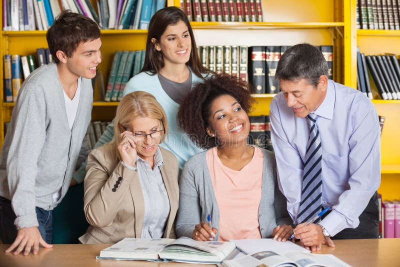 Teachers Discussing with Students in Library Stock Image - Image of ...