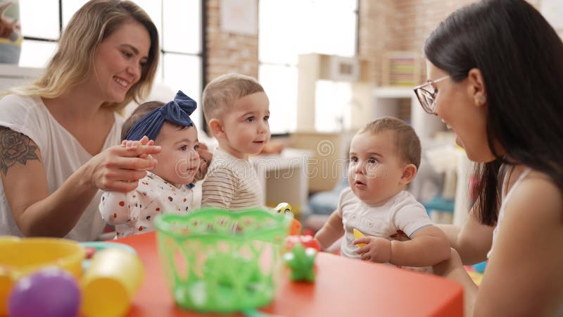 Teachers and Preschool Students Playing with Toys on Table at ...