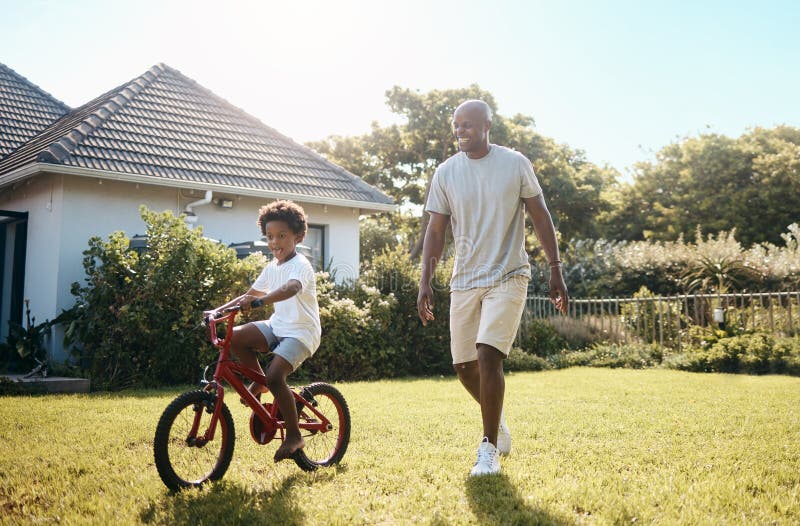 Teaching, Father and Child Riding Bicycle in Backyard for Development ...
