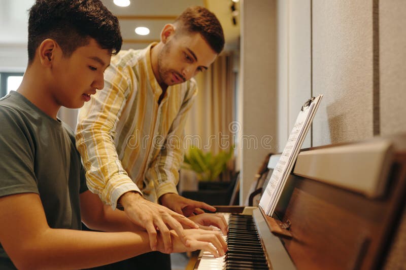Teaching Piano Lessons in Modern Room without Natural Light Stock Photo ...