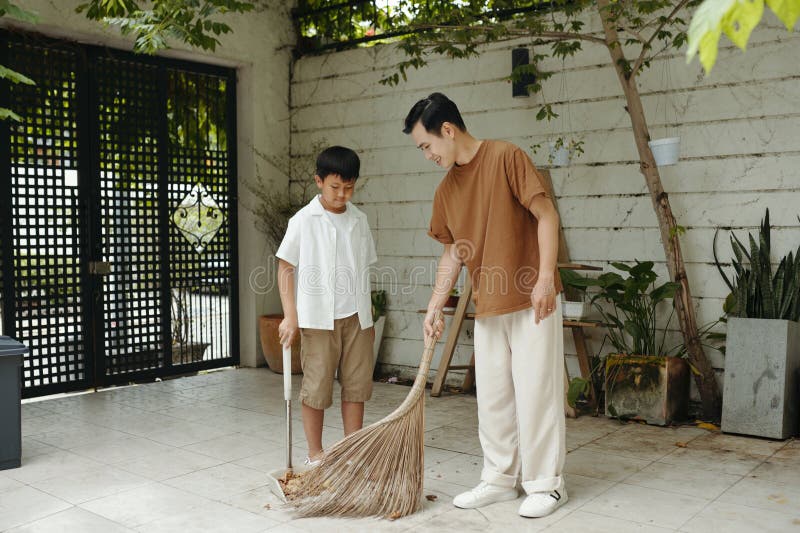 Teaching Young Boy Sweeping Floor in Backyard Stock Image - Image of ...