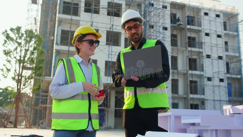 Team Architect and Builder Talking and Holding Laptop Looking Model ...