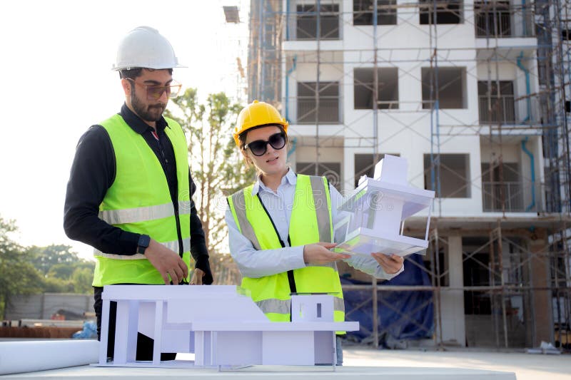 Team Architect and Builder Talking and Holding Model House at ...