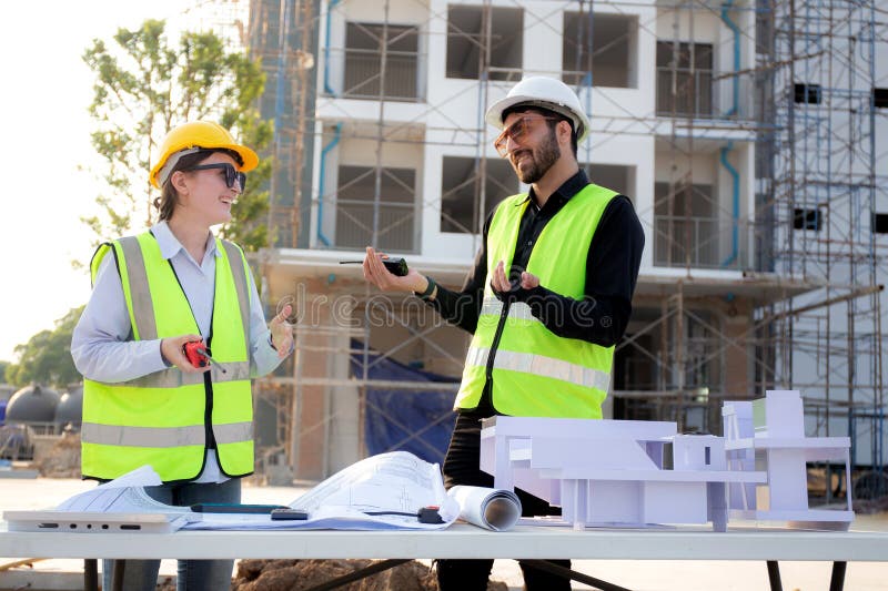 Team Architect and Builder Talking and Holding Model House at ...