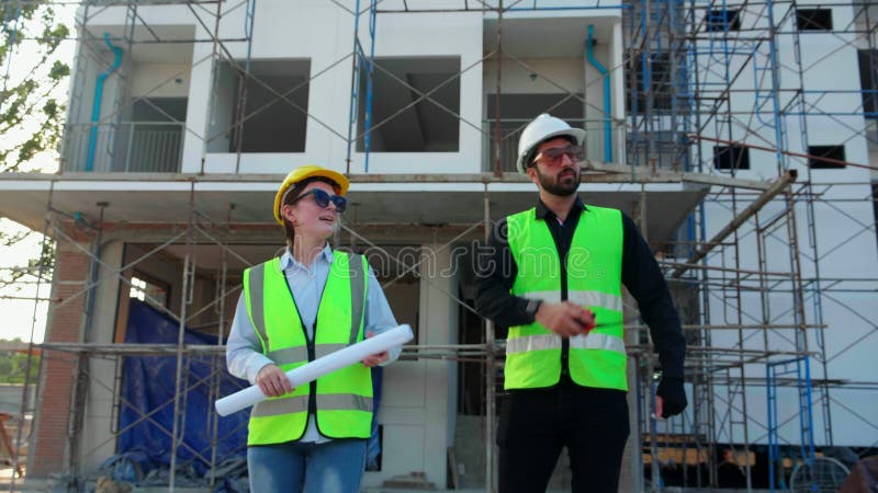 Team Architect or Engineer Man and Woman Walking and Looking Blueprint ...