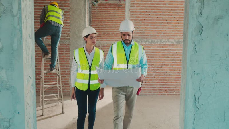 Team Architect or Engineer Man and Woman Walking and Looking Blueprint ...