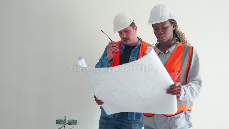 Team of Architect or Engineer Wearing Hardhat Looking Blueprint for ...