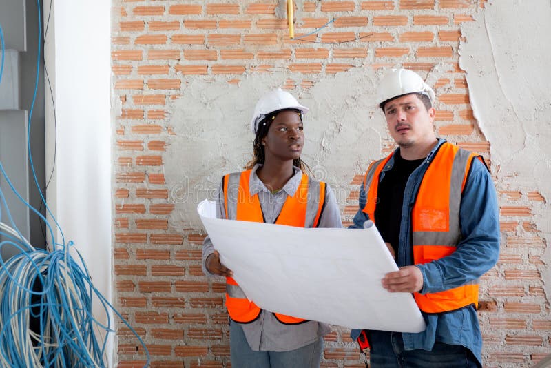 Team of Architect or Engineer Wearing Hardhat Looking Blueprint for ...