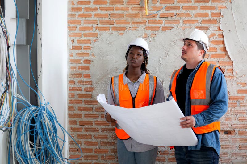Team of Architect or Engineer Wearing Hardhat Looking Blueprint for ...