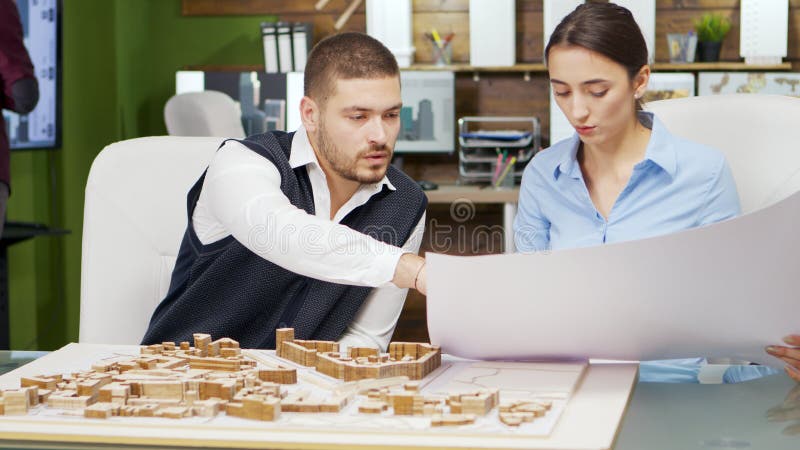 Team of Architect Holding Blue Print and Working with Building Models ...