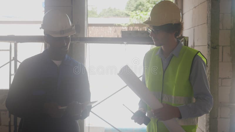 Team Architect Two Young Man Discussing and Looking Digital Tablet for ...
