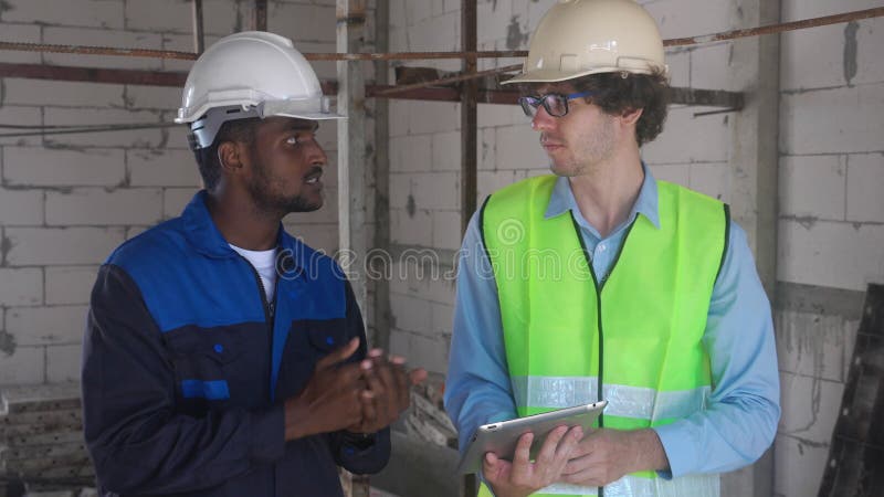 Team Architect Two Young Man Discussing and Looking Digital Tablet for ...