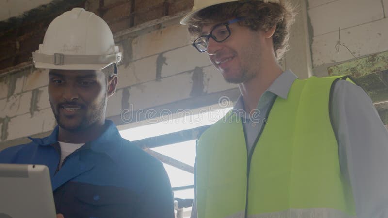 Team Architect Two Young Man Discussing and Looking Digital Tablet for ...