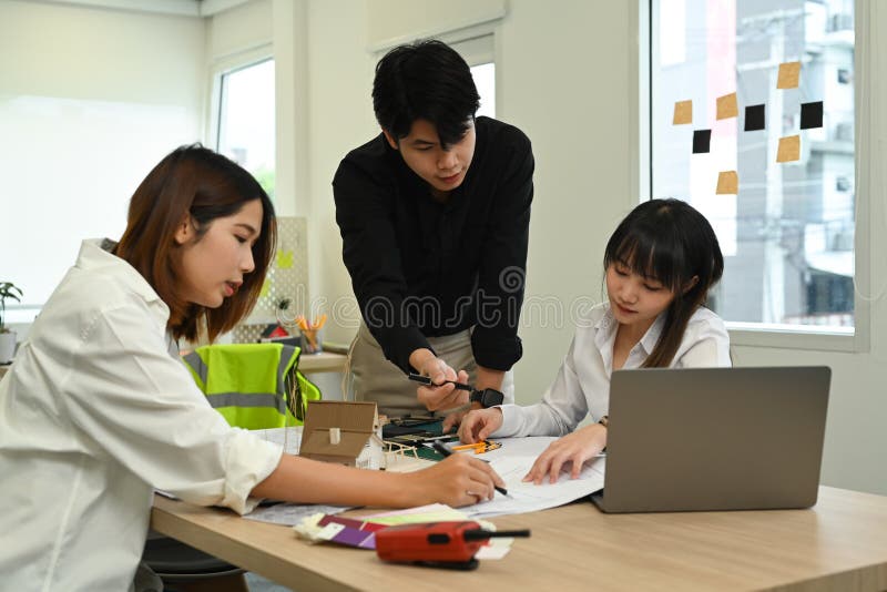 Team of Architects Brainstorming, Working Together on Construction ...