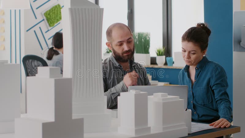Team of Architects Designing Building Model on Laptop in Architectural ...