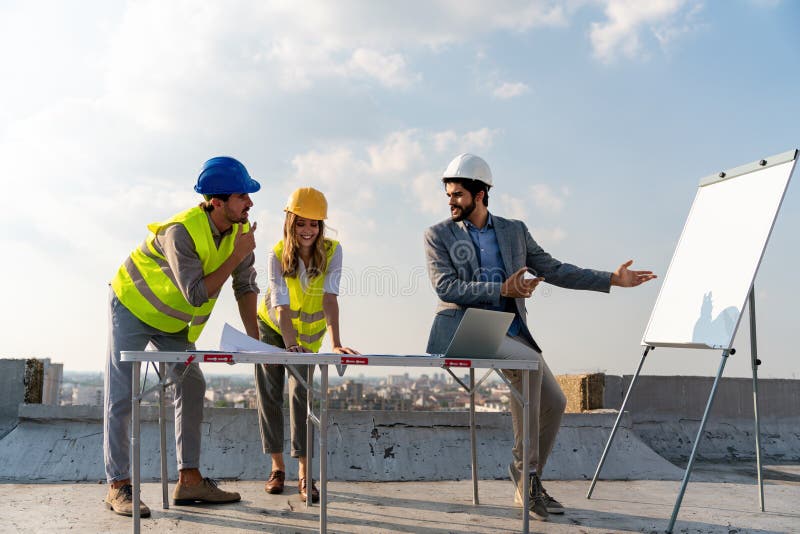 Team of Architects People in Group on Construciton Site Check Documents ...