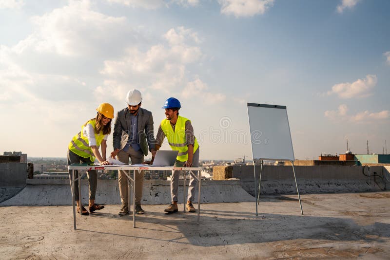 Team of Architects People in Group on Construciton Site Check Documents ...
