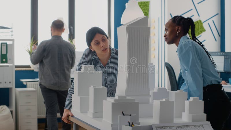Team of Architects Working with Building Model and Maquette To Plan ...