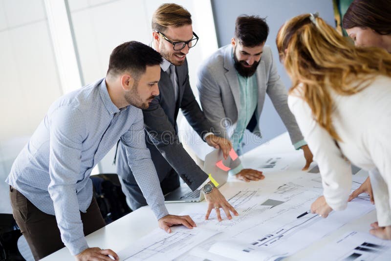 Team of Architects Working on Construction Plans Stock Photo - Image of ...