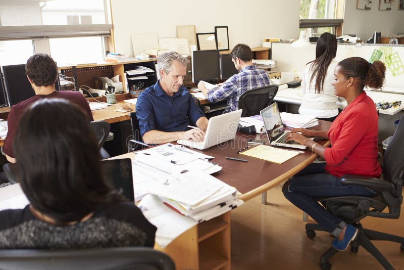 Team Working at Desks in Busy Office Stock Image - Image of industry ...