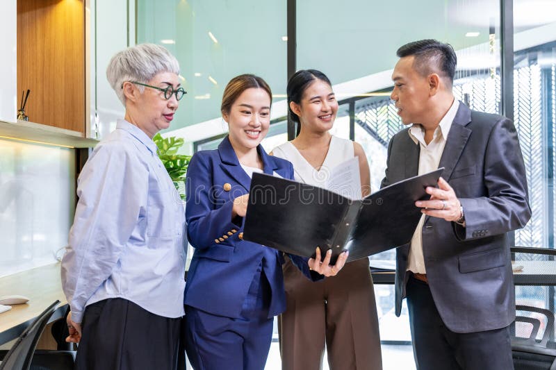 Team of Asian People with Different Age Group Brainstorming on Data and ...