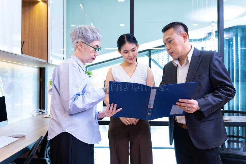 Team of Asian People with Different Age Group Brainstorming on Data and ...