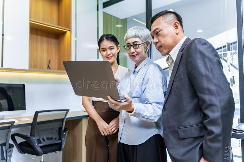 Team of Asian People with Different Age Group Brainstorming on Data and ...