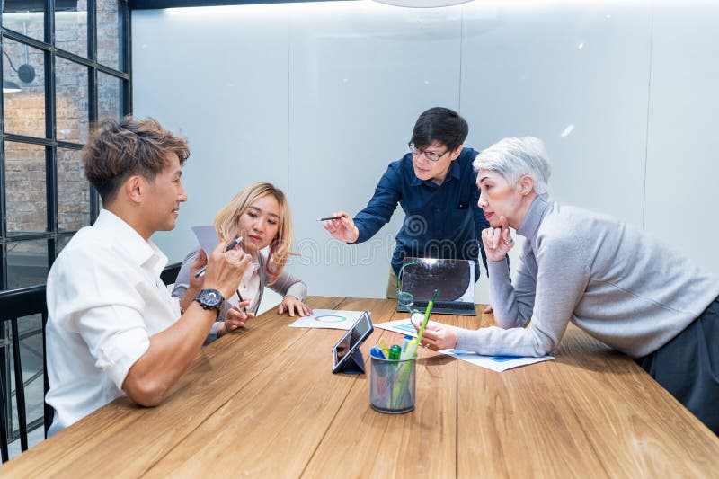 Team of Asian People with Different Age Group Brainstorming on Data and ...