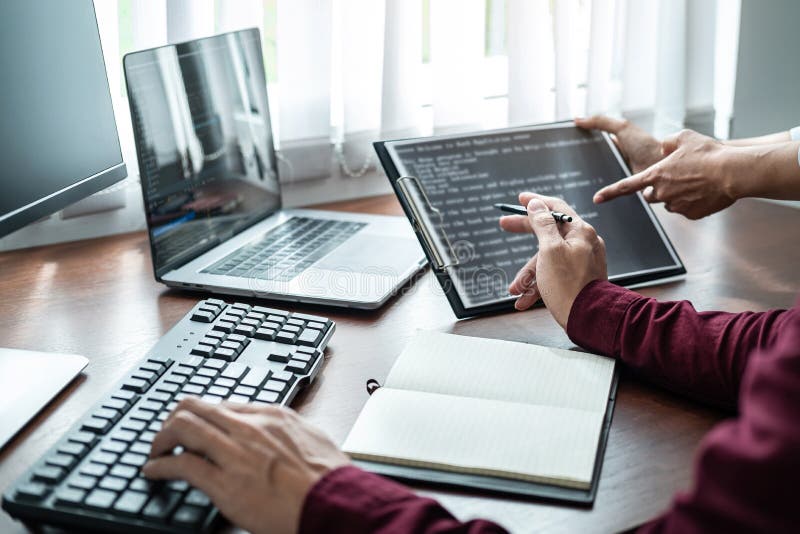 Asian Programmer Woman Pointing and Looking on Multiple Laptop Screen ... Asian Programmer Woman Pointing and Looking on Multiple Laptop Screen ...