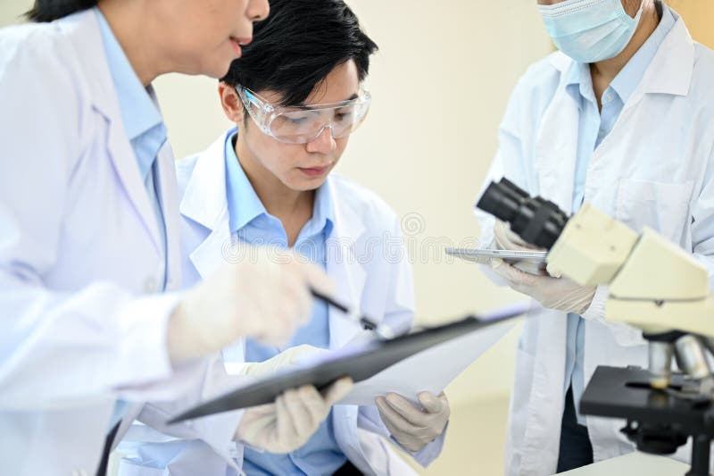 A Team of Asian Technician or Scientist Working Together in the Lab ...
