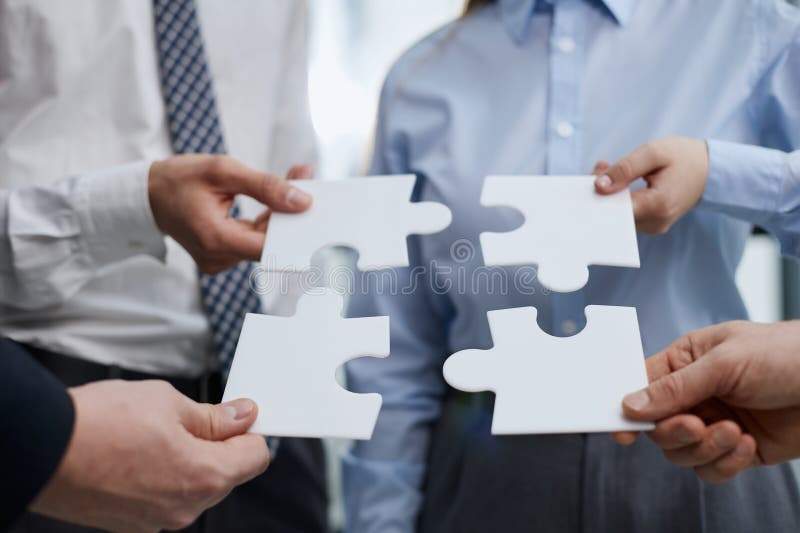 The Team Assembles the Puzzle while Standing in the Office Stock Photo ...