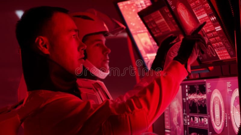 Team of Astronauts in a Space Suits Aboard the Orbital Station. a Crew ...