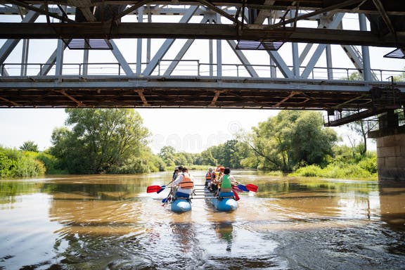 A Team of Athletes on a Catamaran Overcomes Obstacles Floating on the ...