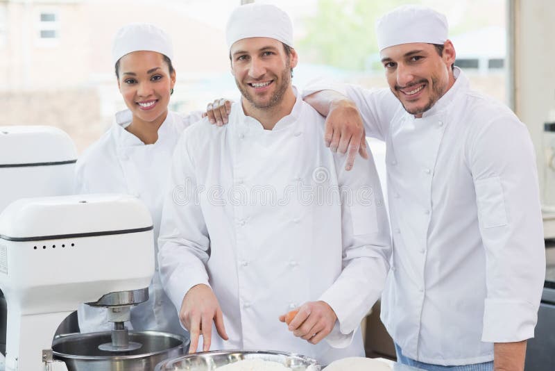 Team of Bakers Smiling at Camera Stock Photo - Image of bakery ...